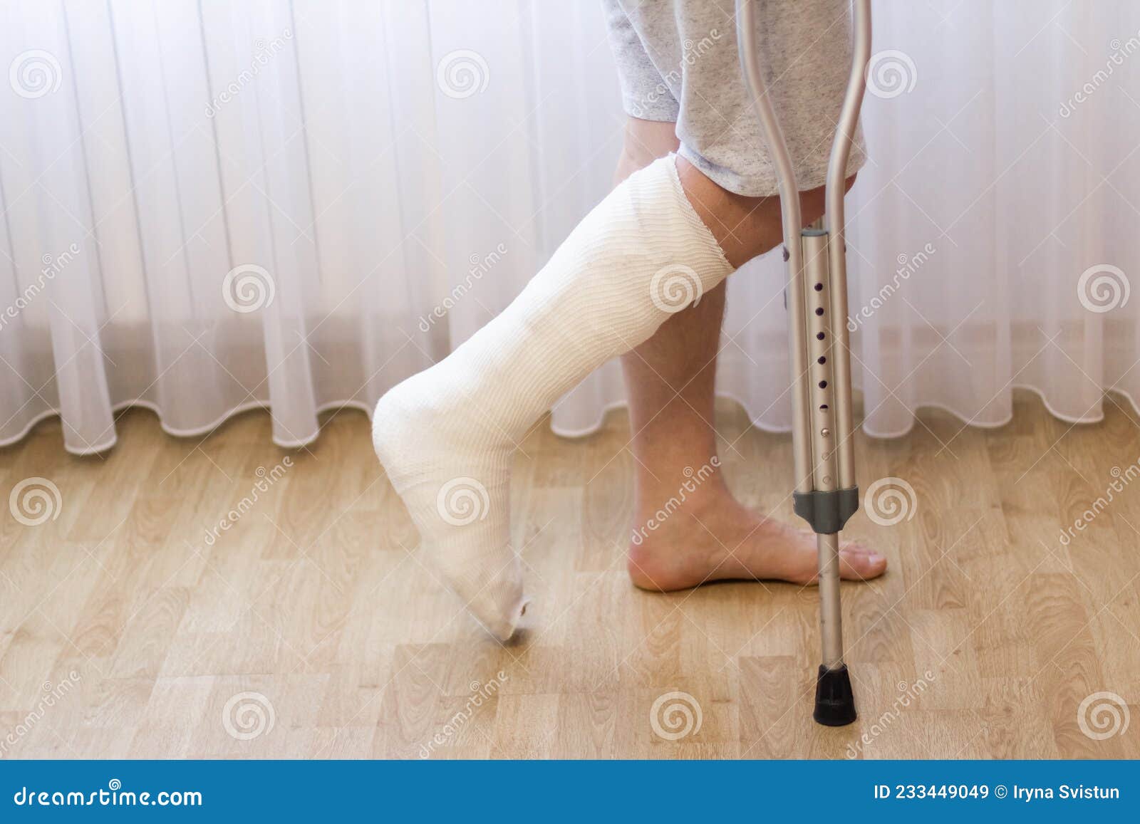 Close-up of Man Leg in Plaster Cast Using Crutches while Walking. Stock ...
