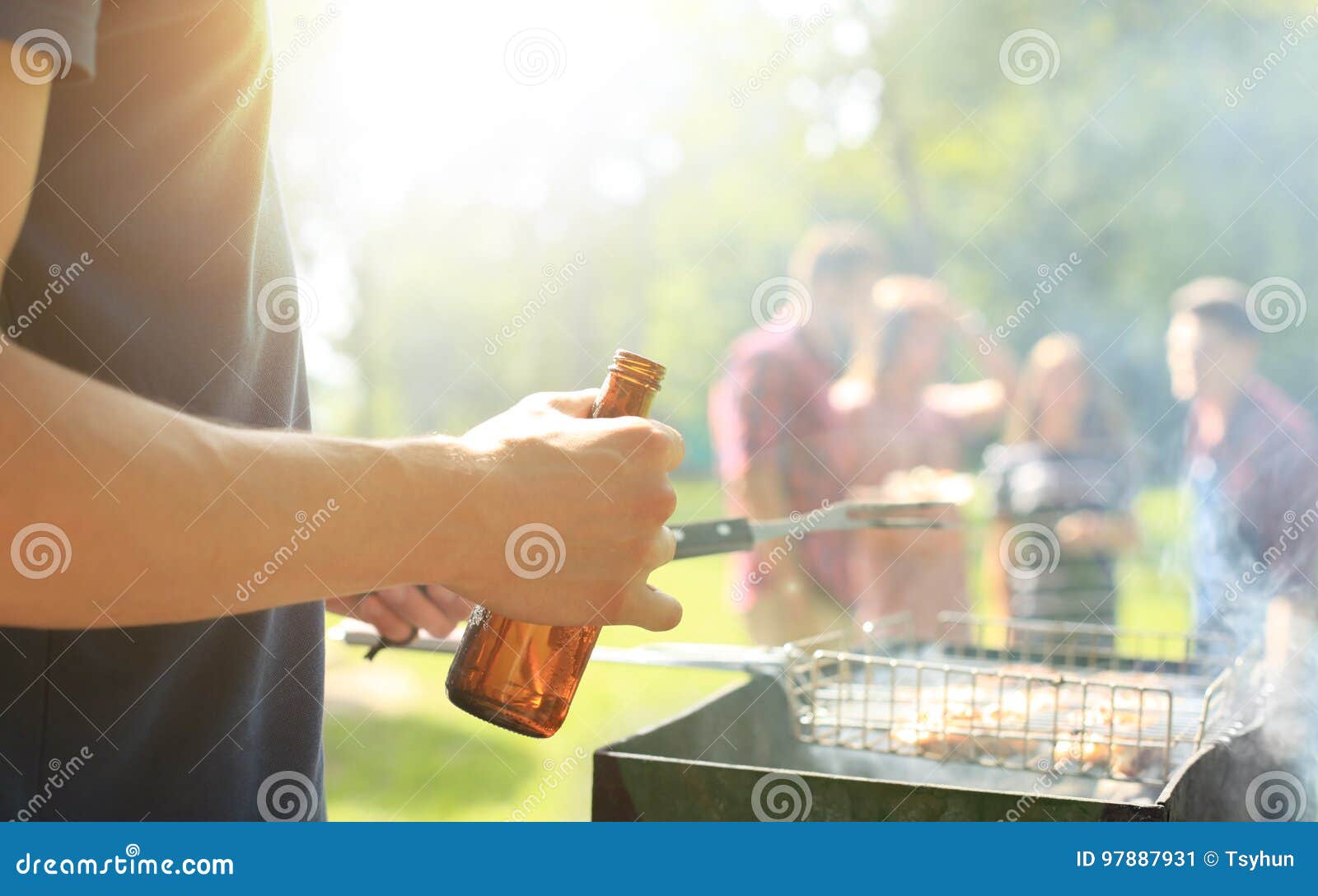 Close Up of a Man Making Barbecue and Holding Beer Bottle. Stock Image ...