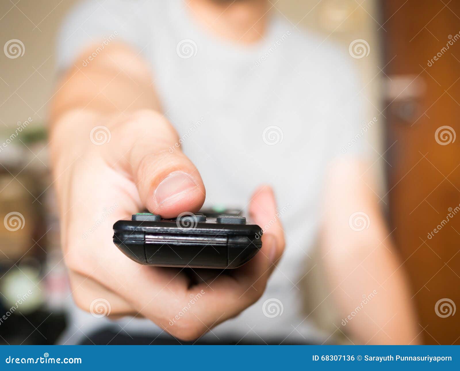 Close Up of Man Pressing a Button on Remote Control (shallow Depth of ...