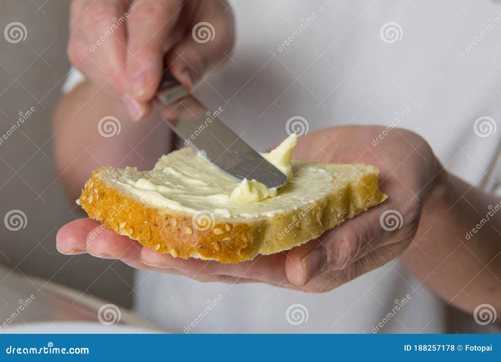 Spread butter on bread stock photo. Image of creamy - 188257178