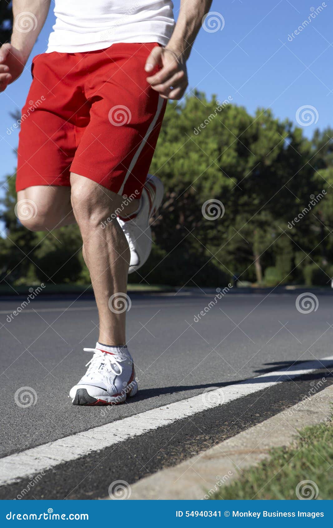 Close Up of Man Running on Road Stock Image - Image of athletic, male ...