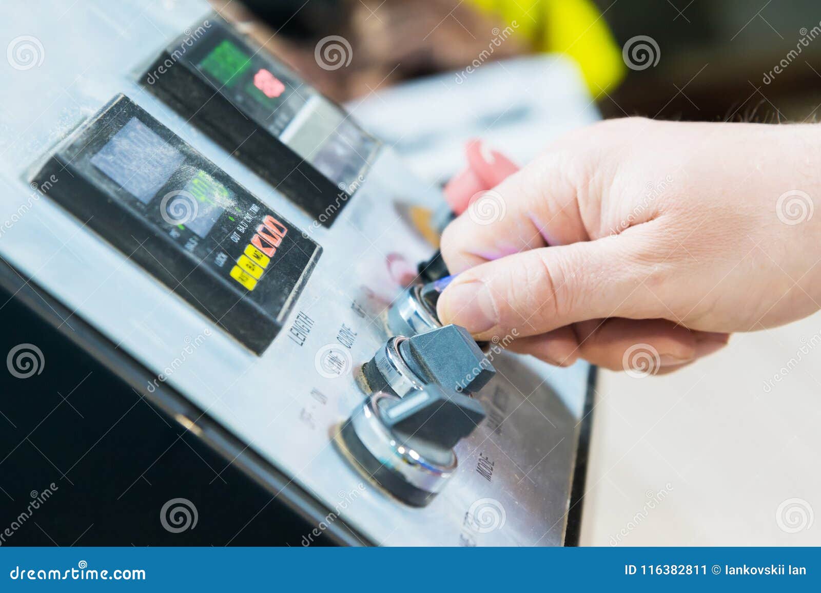 A Close-up of a Man`s Hand Holds a Rotary Switch on the Equipment ...