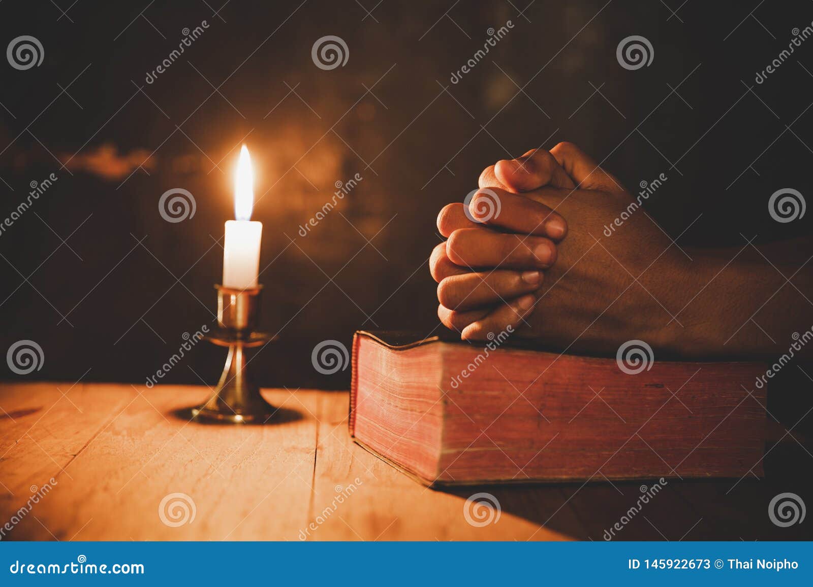 Close Up Man`s Hand is Praying in the Church with Lit Candle Stock ... Close Up Man`s Hand is Praying in the Church with Lit Candle Stock ...
