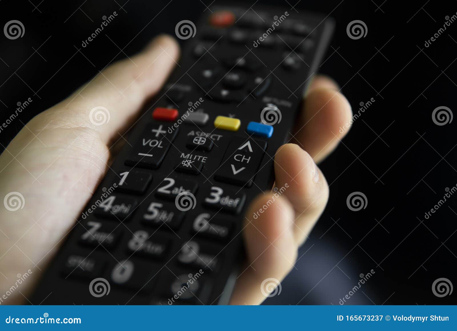 Close Up on a Man`s Hand with the Remote Control Want Switch on the TV ...
