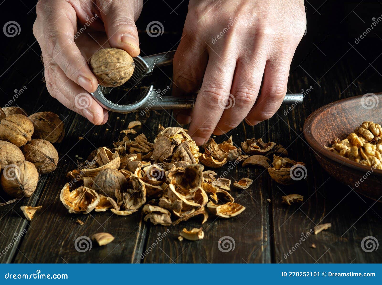 Close-up of a Man S Hands with Nutcracker on Kitchen Table. Peeling ...