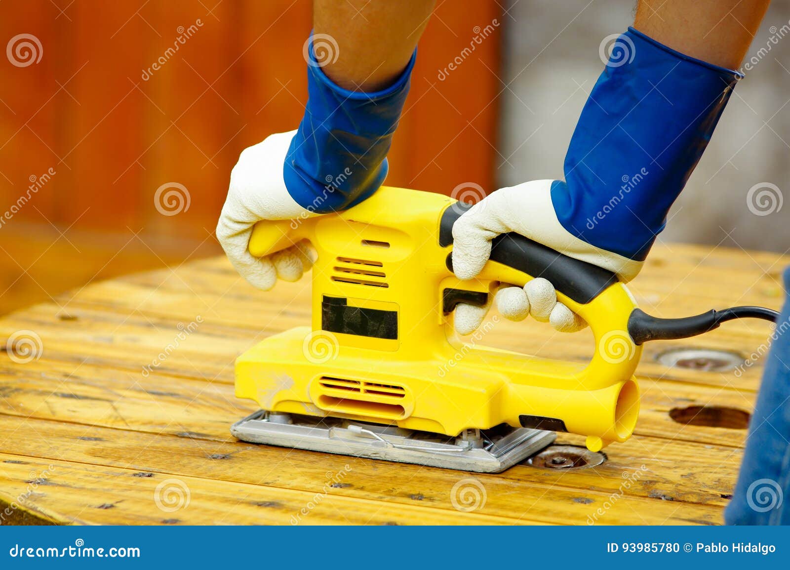 Close Up of a Man Using an Electric Sander on Pine Floor or Table ...