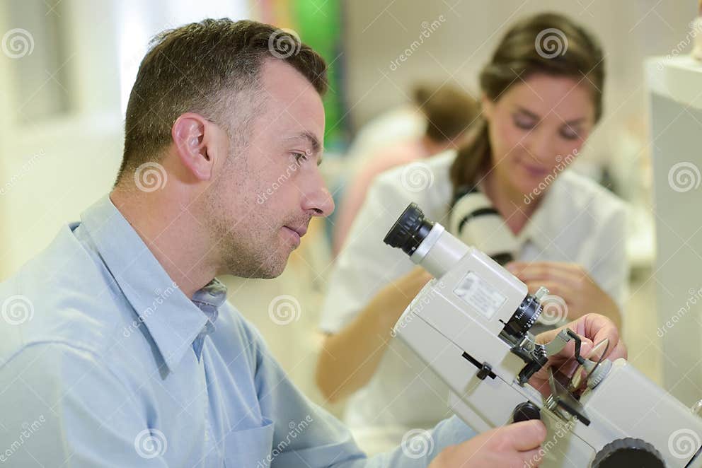Close Up Man Using Microscope Stock Image - Image of professional ...