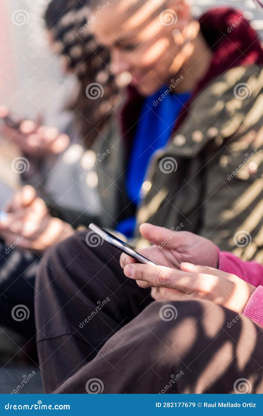 Close Up of a Man Using Mobile Phone with Friends Stock Image - Image ...