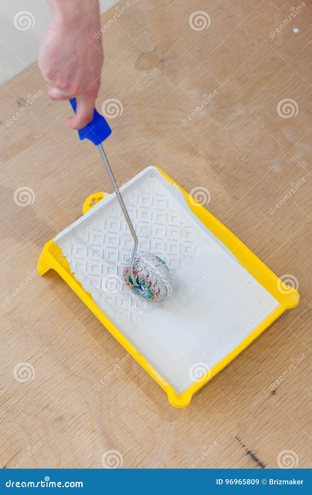Close-up of Mans Hands Using Paint Roller while Working Indoors. Stock ...