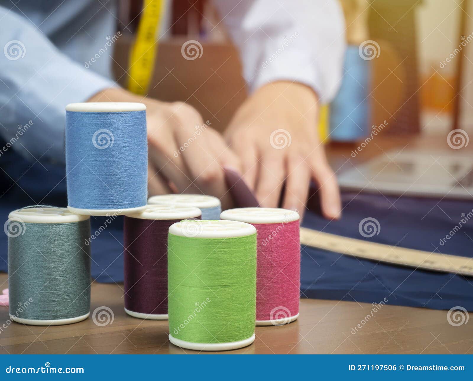 Close Up of Many Spool of Thread and Blurred Behind with Woman Tailor ...