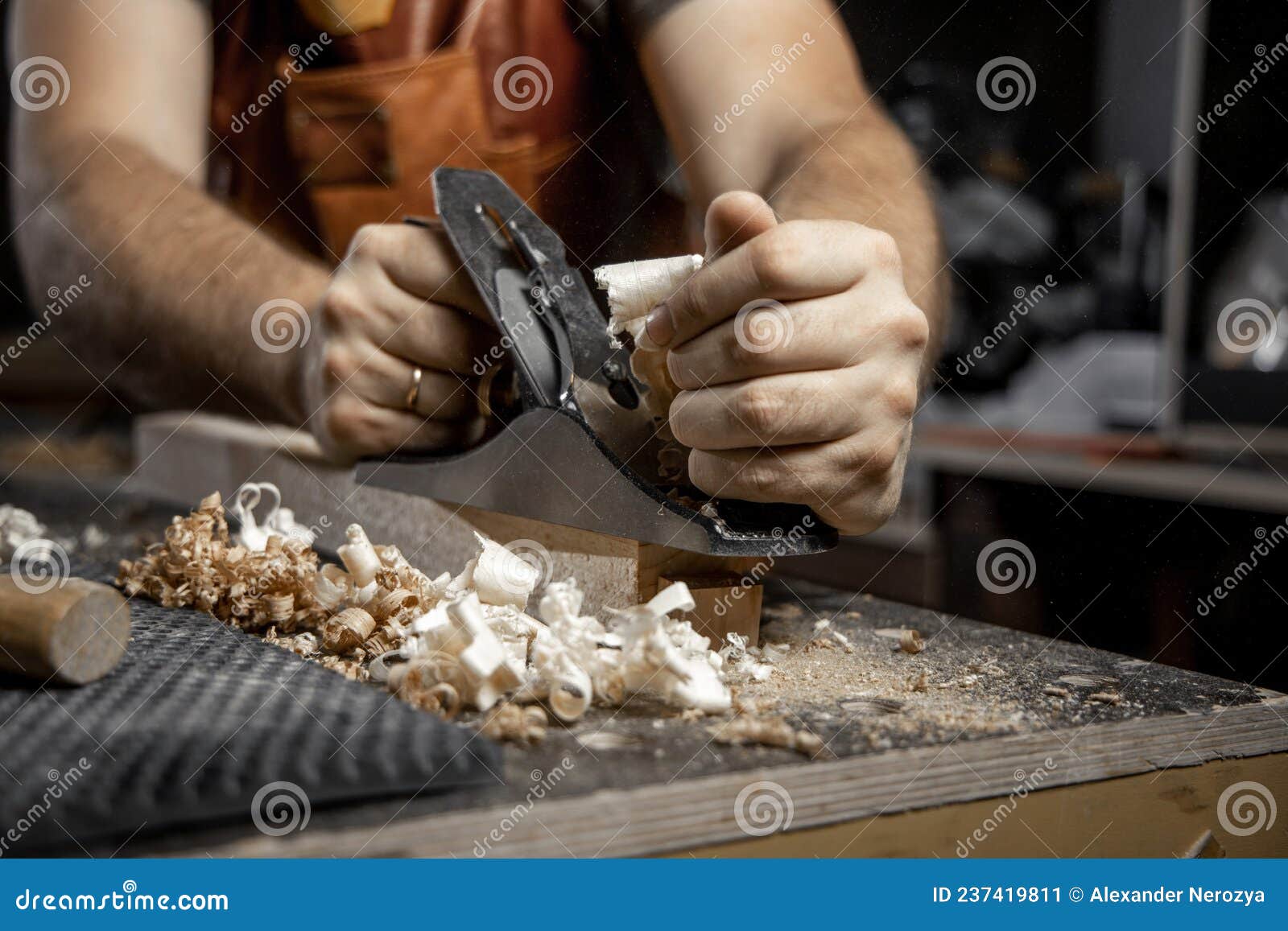 Close Up Master Carpenter in an Apron Planes Tree with a Plane in ...