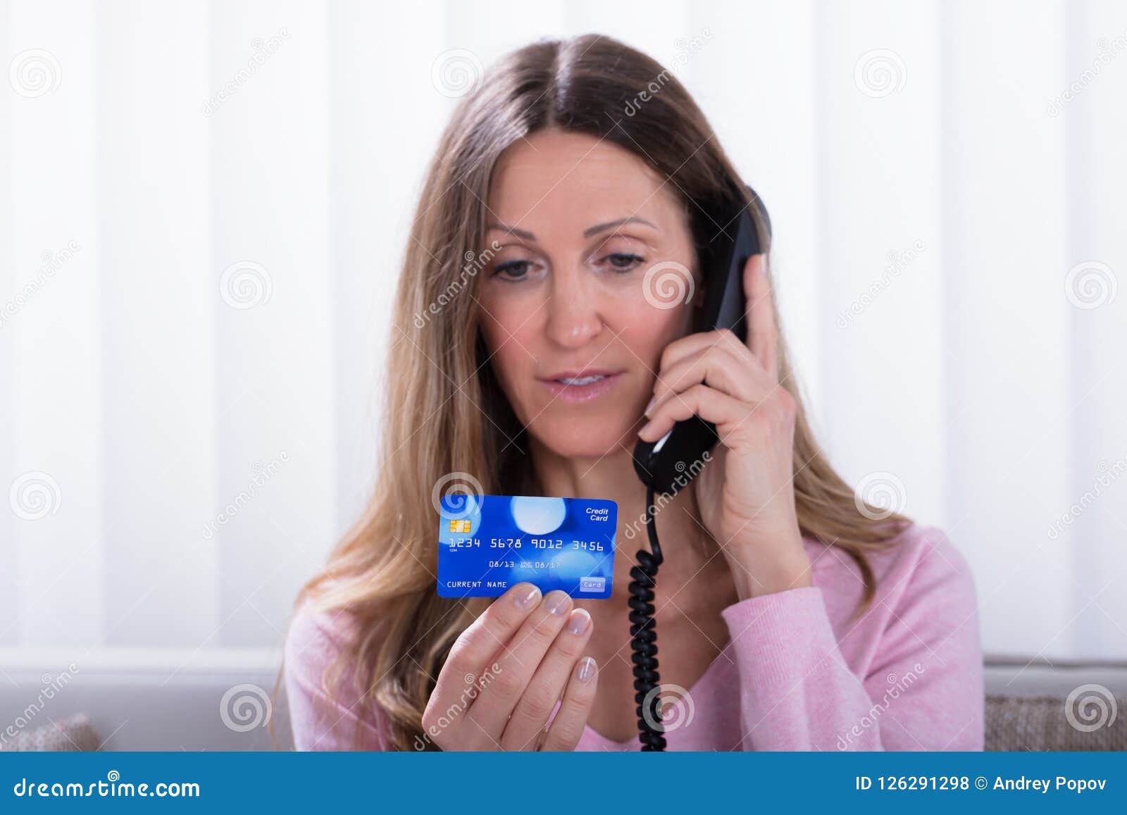 Woman Holding Credit Card while Talking on Telephone Stock Photo ... Woman Holding Credit Card while Talking on Telephone Stock Photo ...