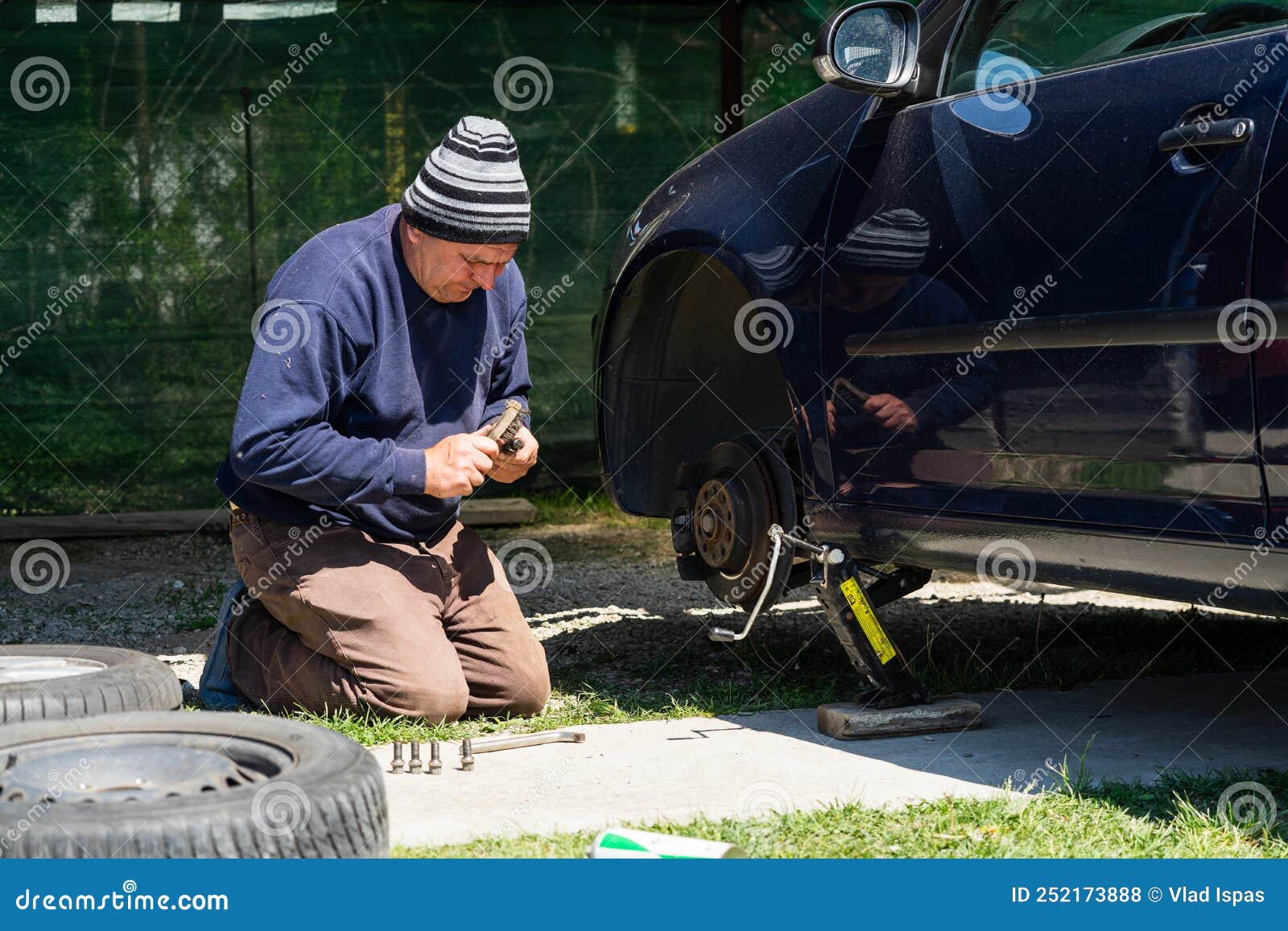 Close Up of Mechanic Changing Wheel on Car with Hand Tool in Romania ...