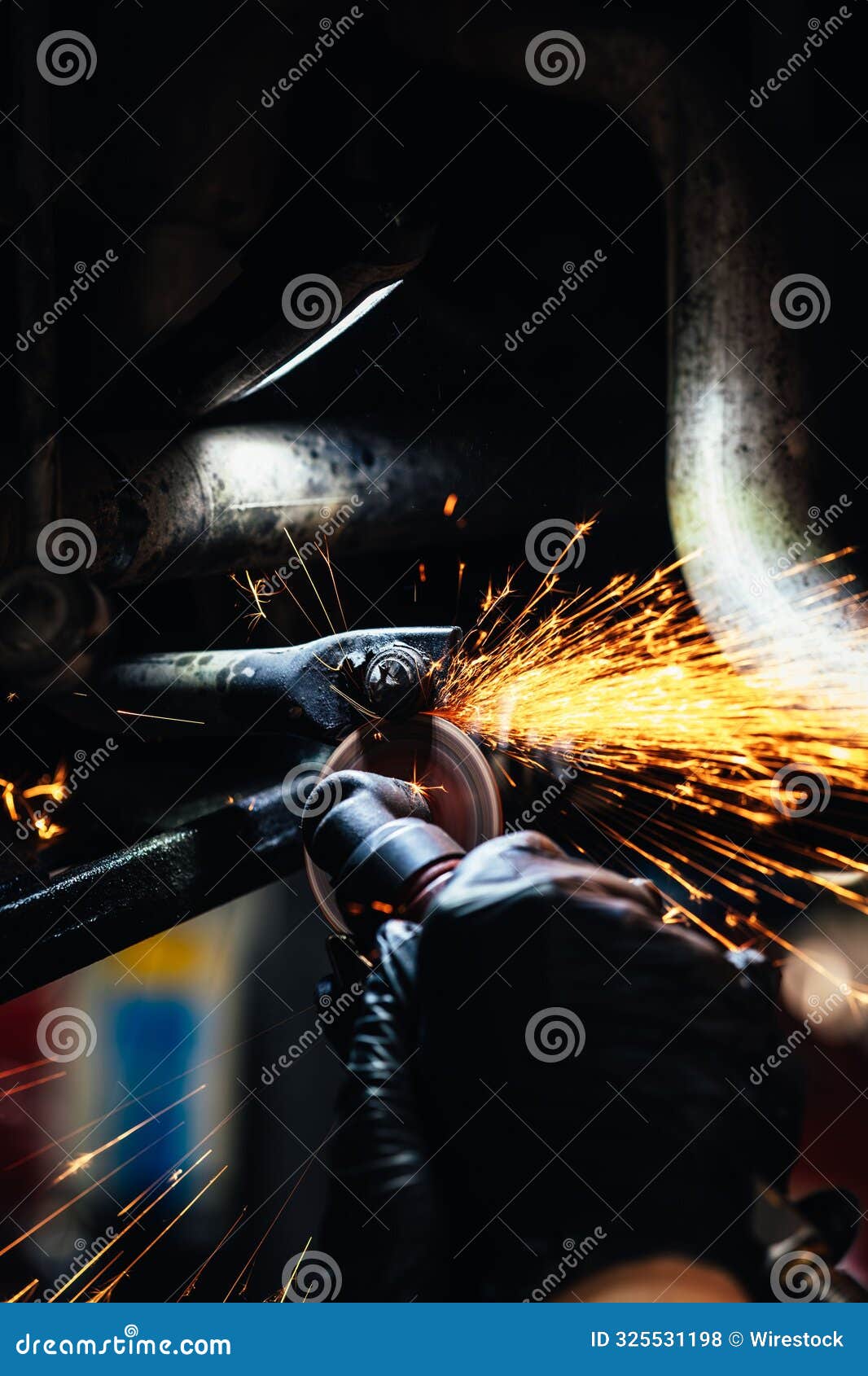 Close-up of a Mechanic Using an Angle Grinder, Creating a Burst of ...
