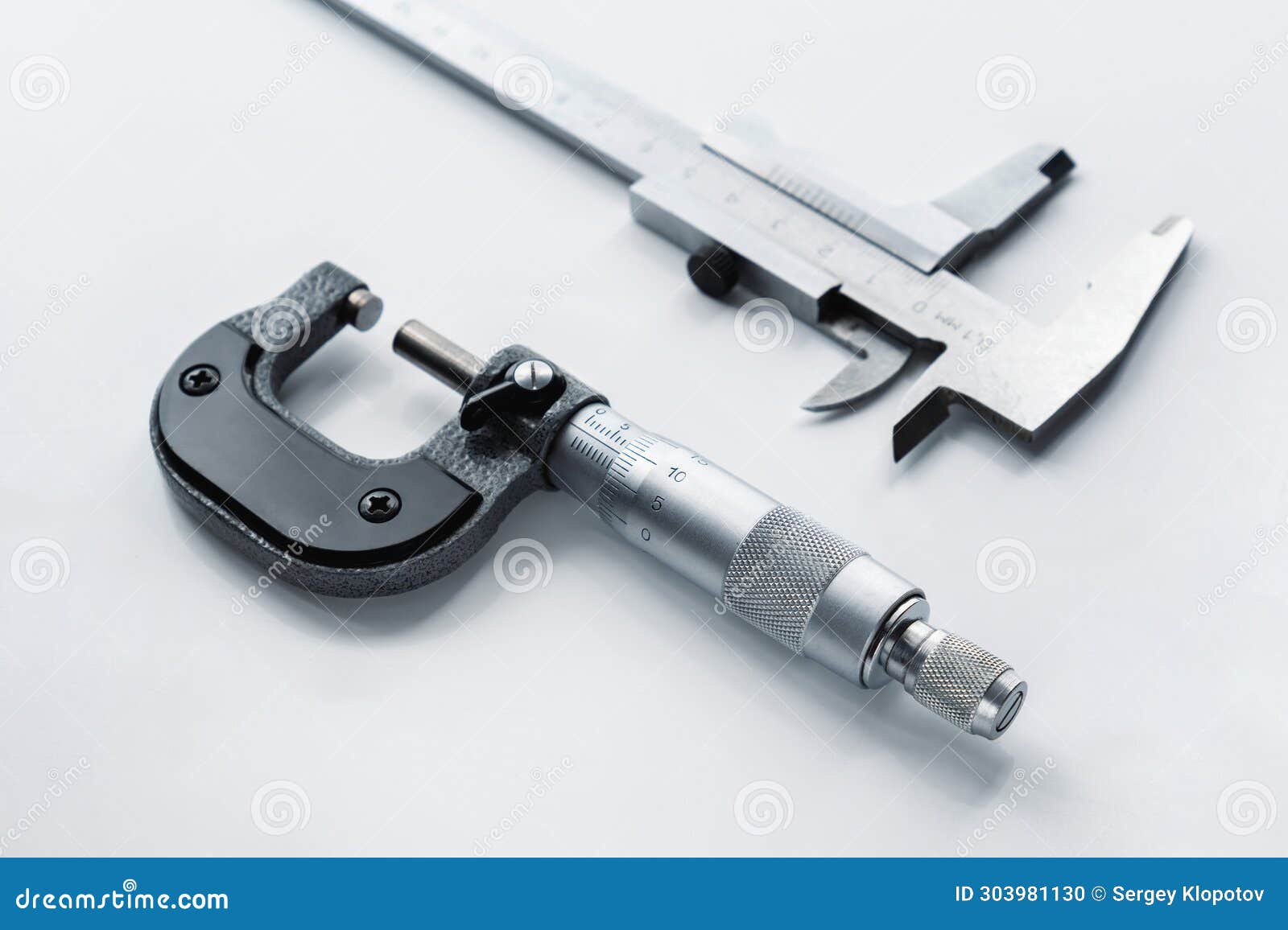 Close-up of a Mechanical Micrometer and Caliper on a Light Background ...