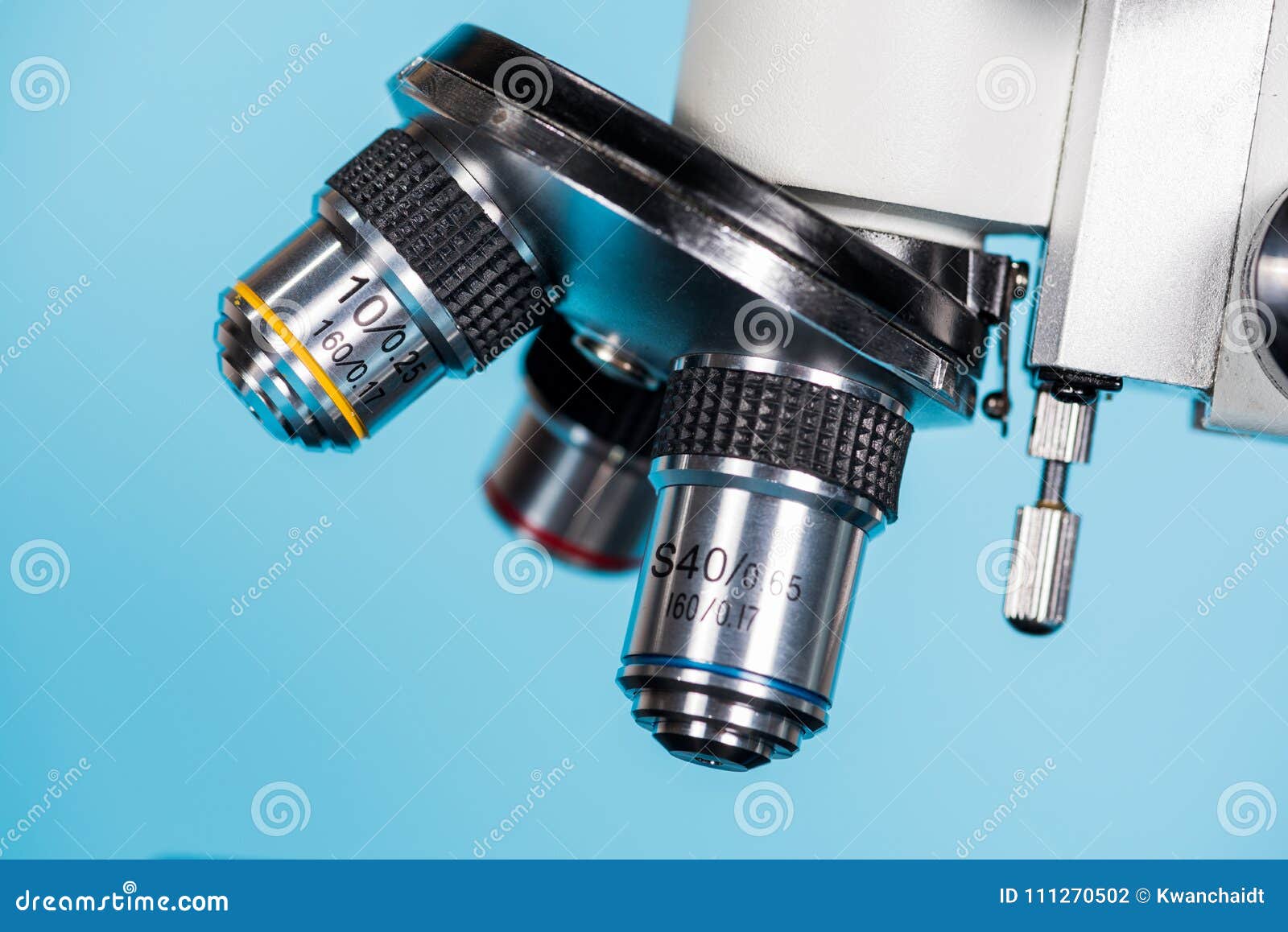 Close Up of Microscope Len on Light Blue Background Stock Photo - Image ...