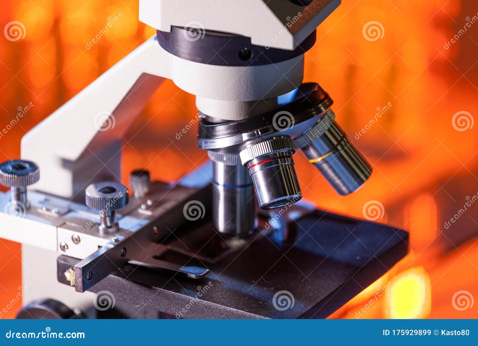 Close Up of Microscope Lenses Focused on a Specimen in Warm Orange ...
