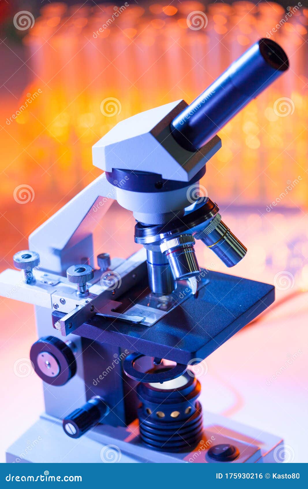Close Up of Microscope Lenses Focused on a Specimen in Warm Orange ...