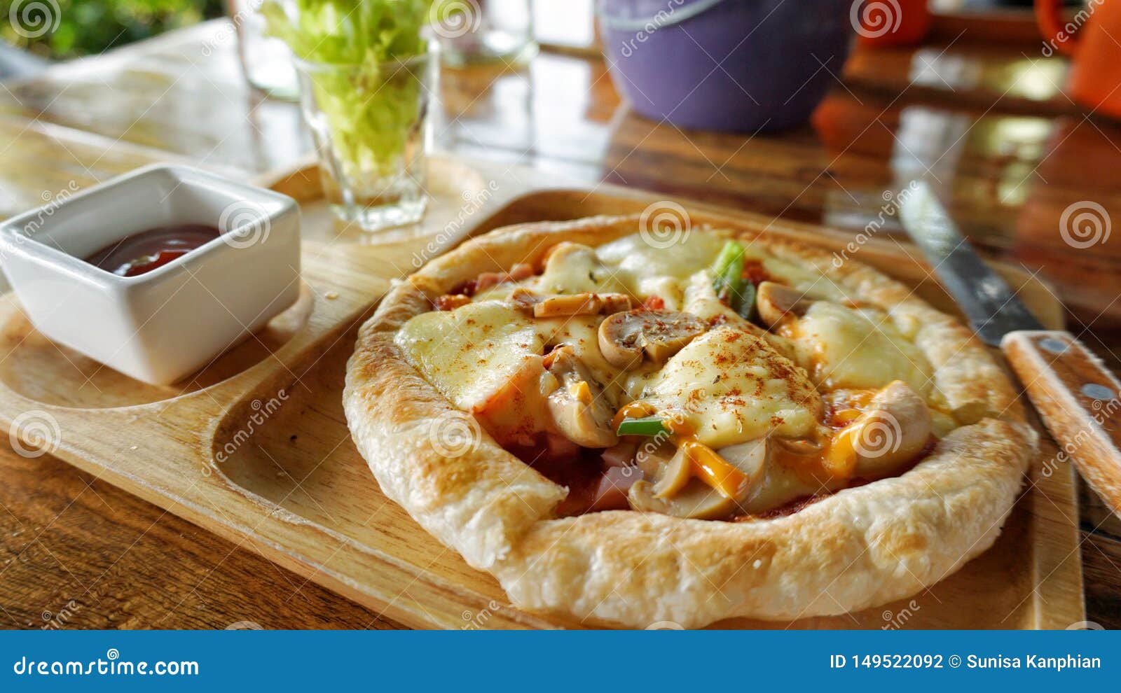Mini pizza on wooden plate stock photo. Image of cooked - 149522092