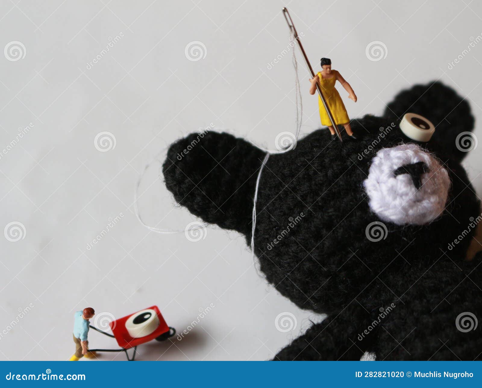 A Close Up of a Miniature Tailor Figure Sewing Stock Photo - Image of ...