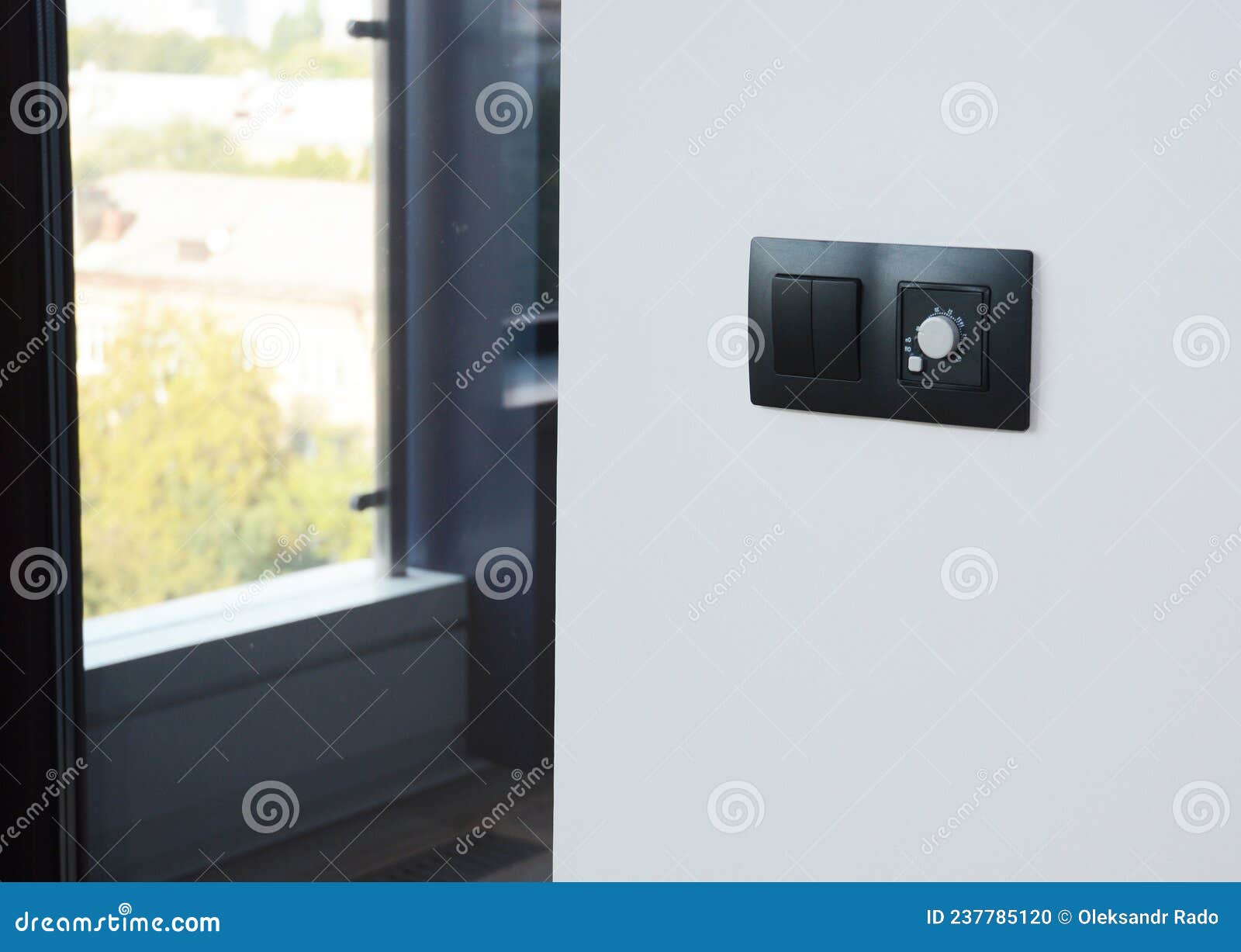 A Close-up of a Modern Elegant Black Light Switch and a Climate ...