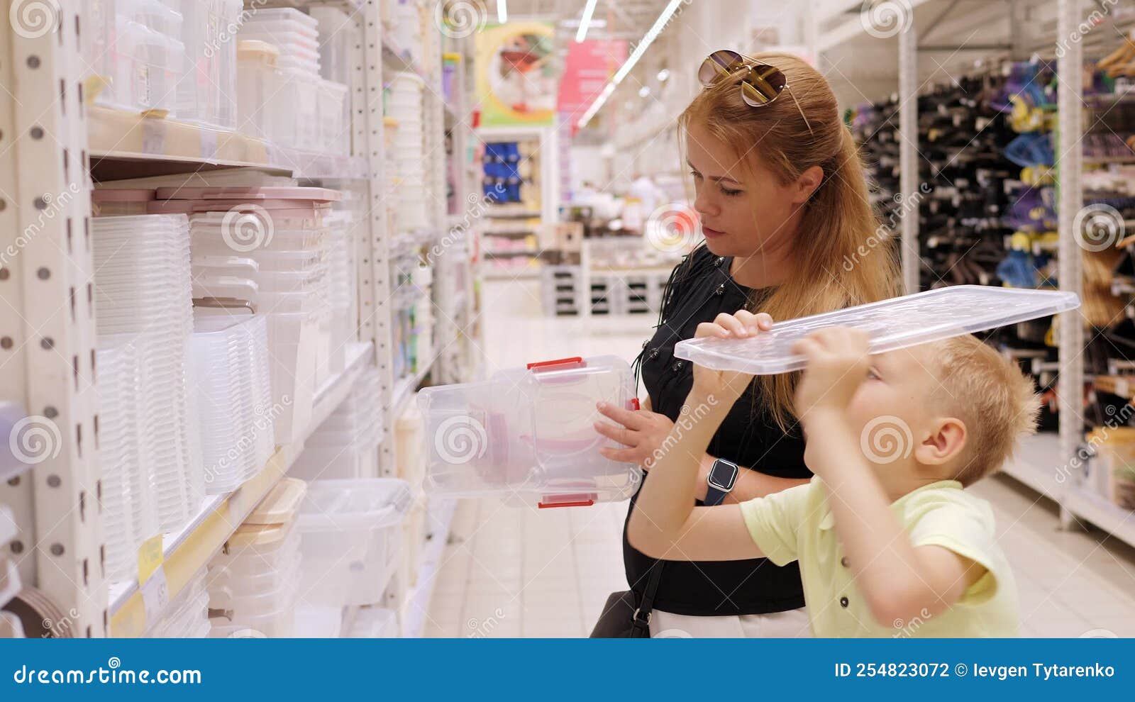 Close-up of a Mother and Son Choosing a Large Plastic Container in a ...