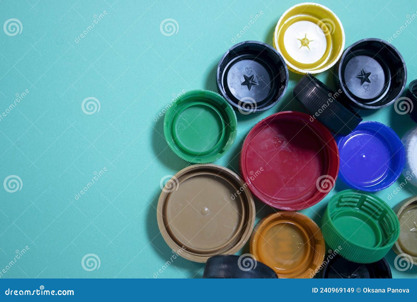 Close-up of Multi-colored Plastic Lids. Plastic Lids on a Blue ...
