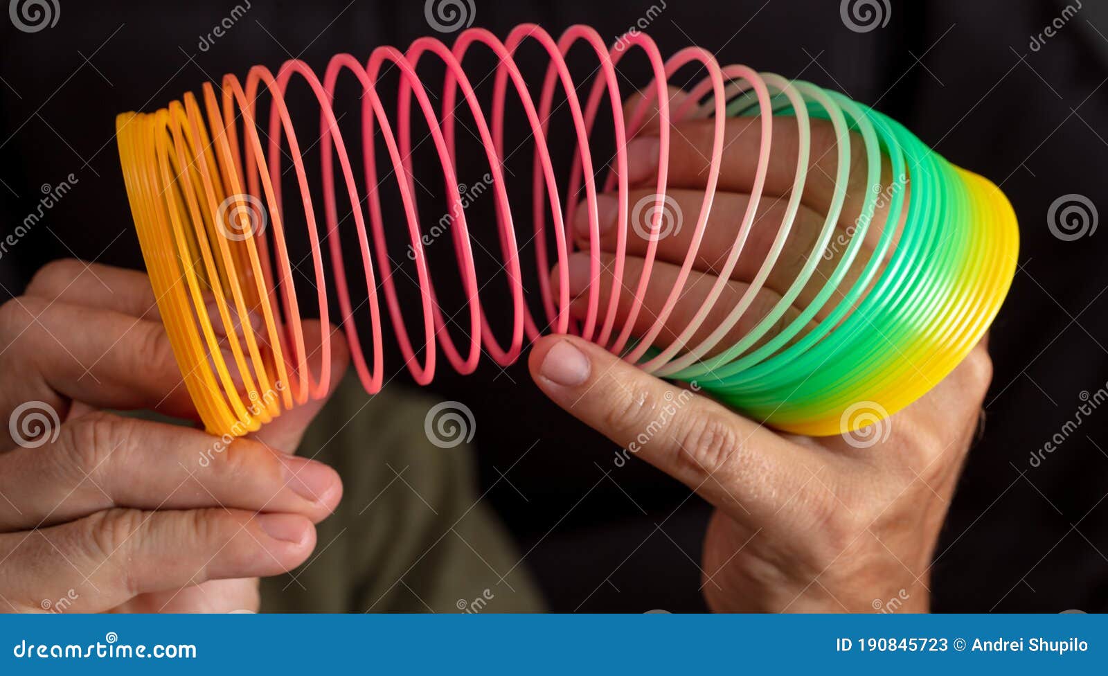 Close-up of a Multi-colored Slinky Spring in a Hand Editorial Stock ...