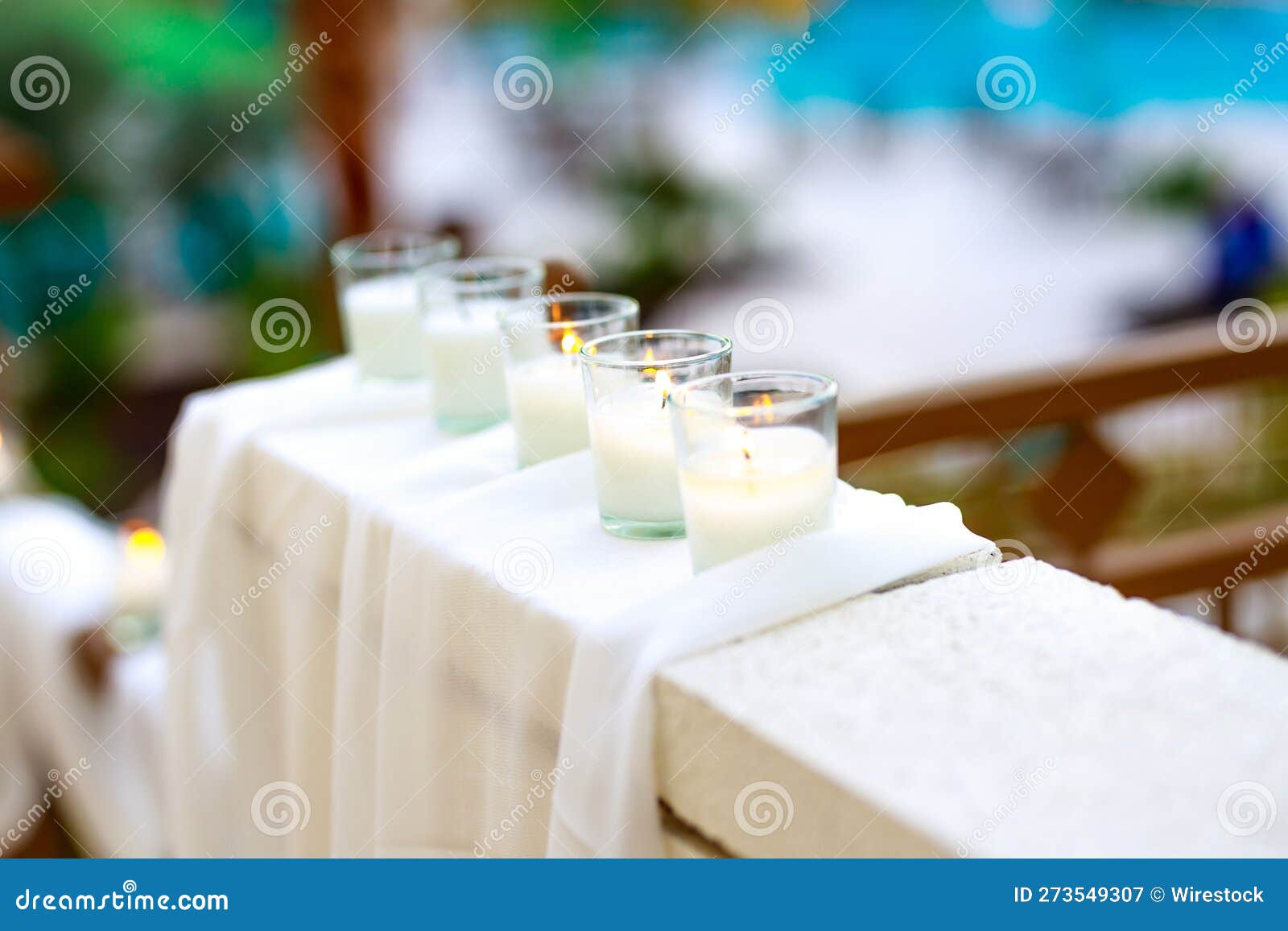 Close-up of Multiple Lit Candles Arranged on a White Table in a Natural ...