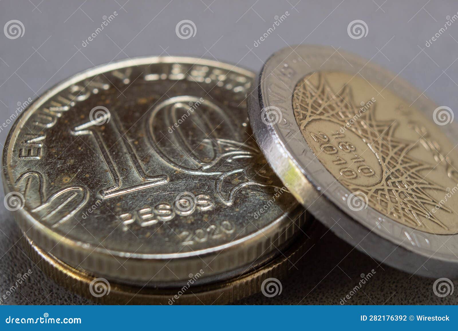 Close-up of Multiple Pesos Coins Neatly Stacked Against a Plain Gray ...