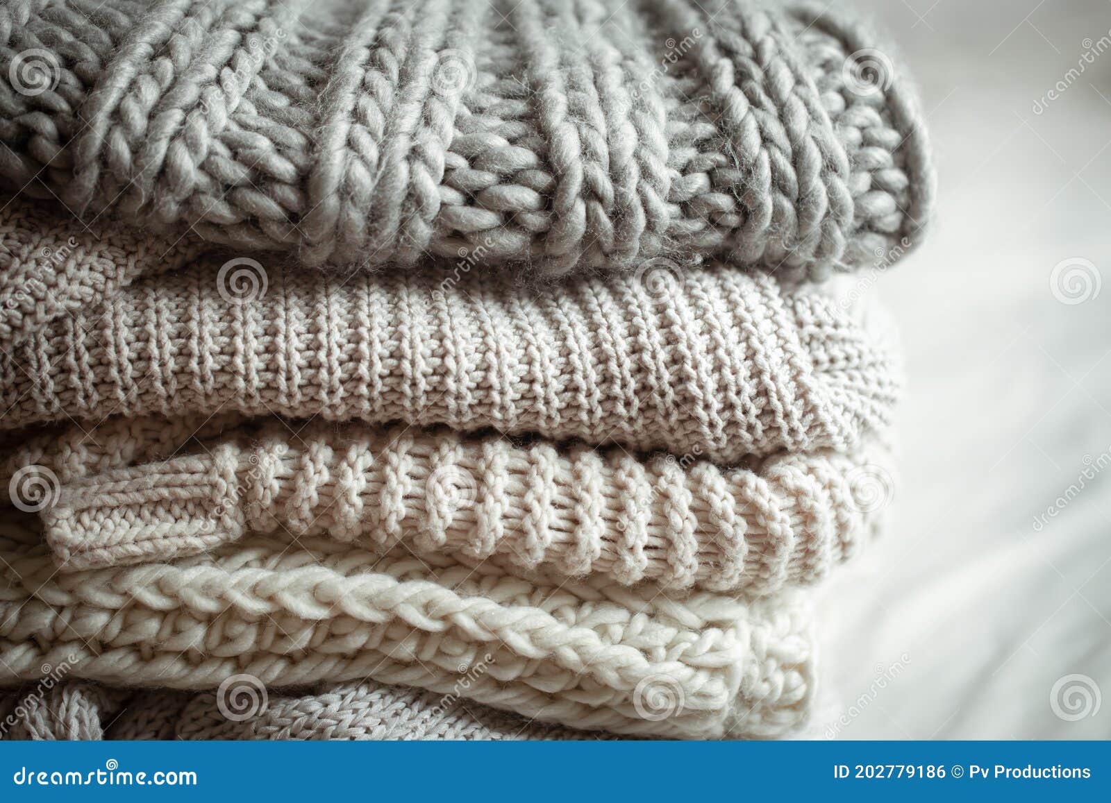 Close Up of Neatly Folded Knitted Items on a Light Background Stock ...