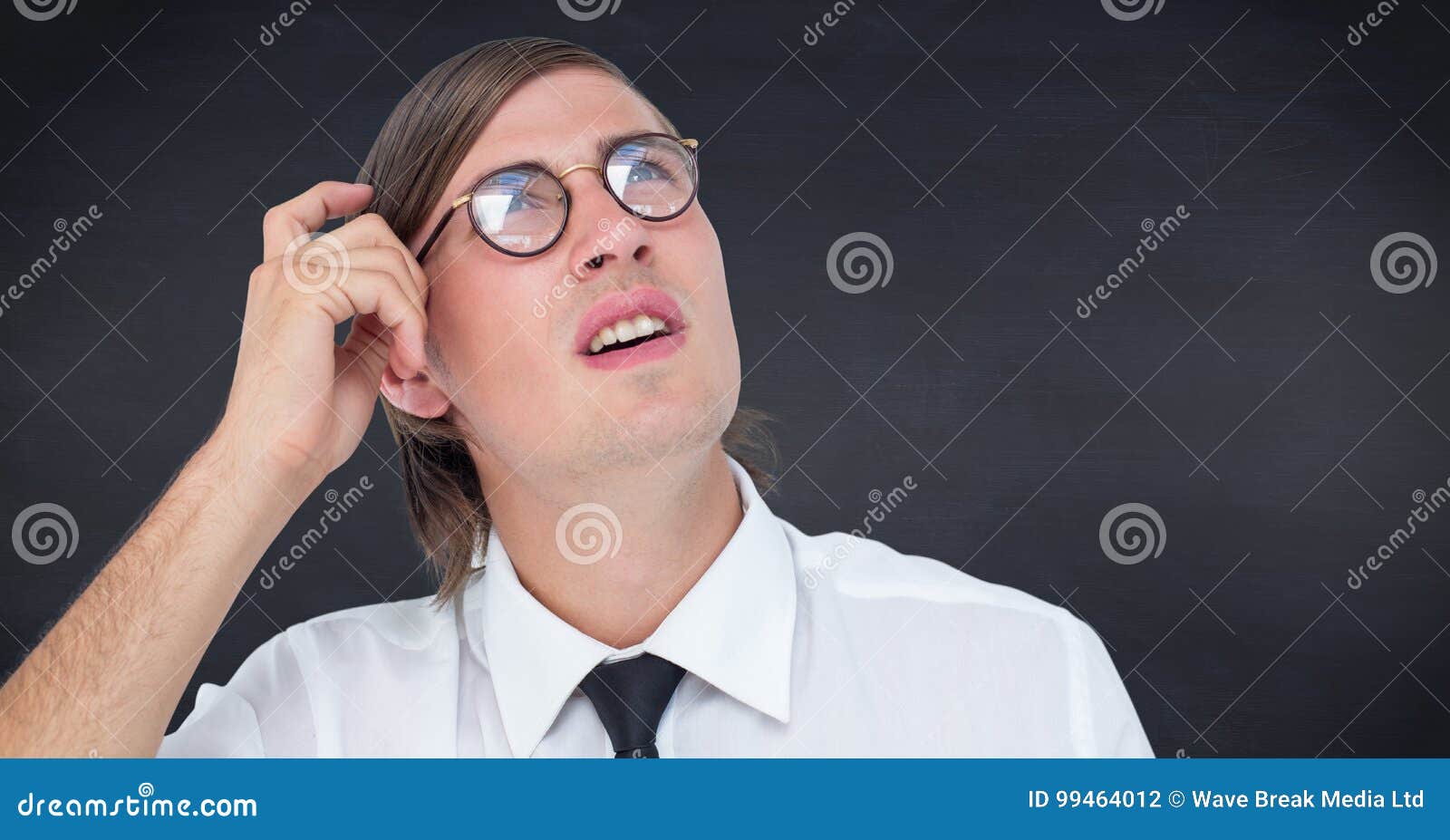 Close Up of Nerd Man Scratching Head Against Navy Chalkboard Stock ...