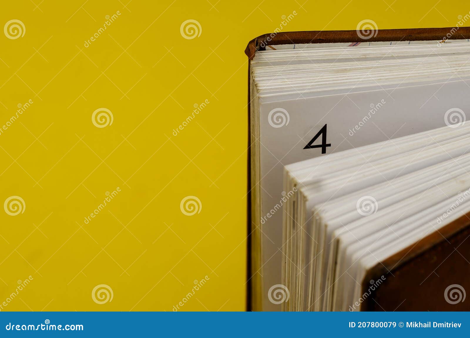 Close-up of an Old Diary Standing on the Endpaper Against a Yellow ...