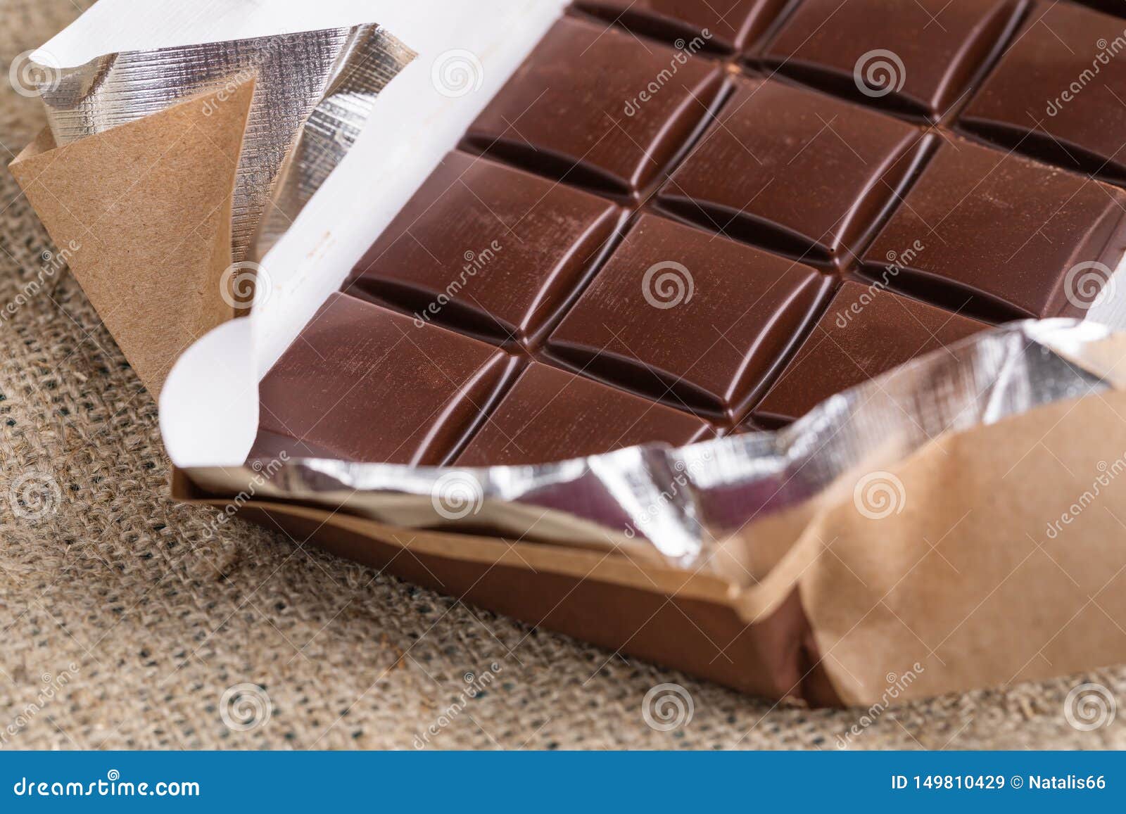 Close-up Part of Chocolate in Opened Wrapper on Burlap. Stock Image ...
