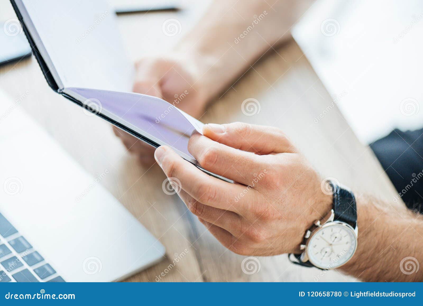 Close-up Partial View of Male Hands Holding Notebook Stock Photo ...