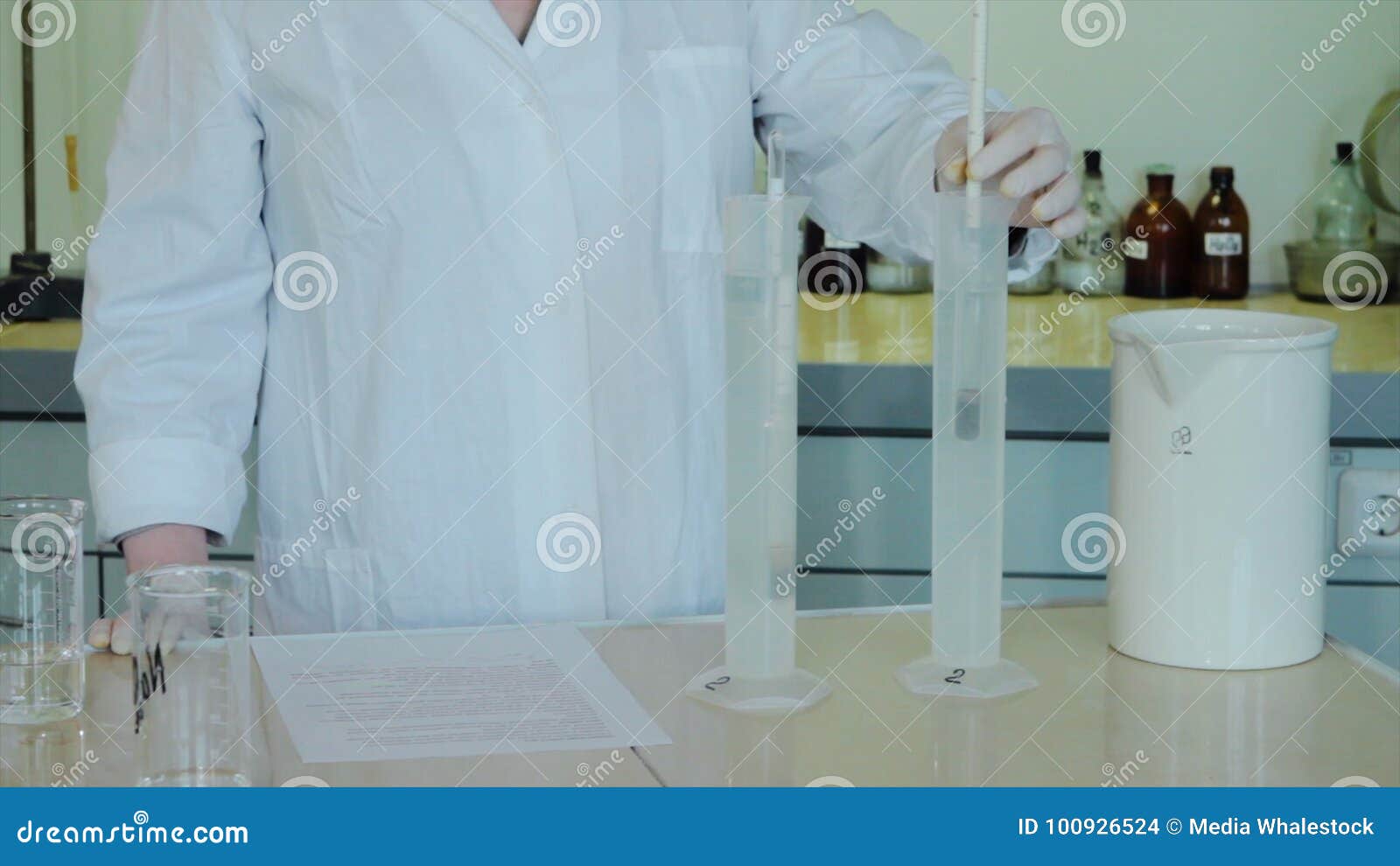 Close-up Partial View of Scientists Making Experiment with Reagent and ...