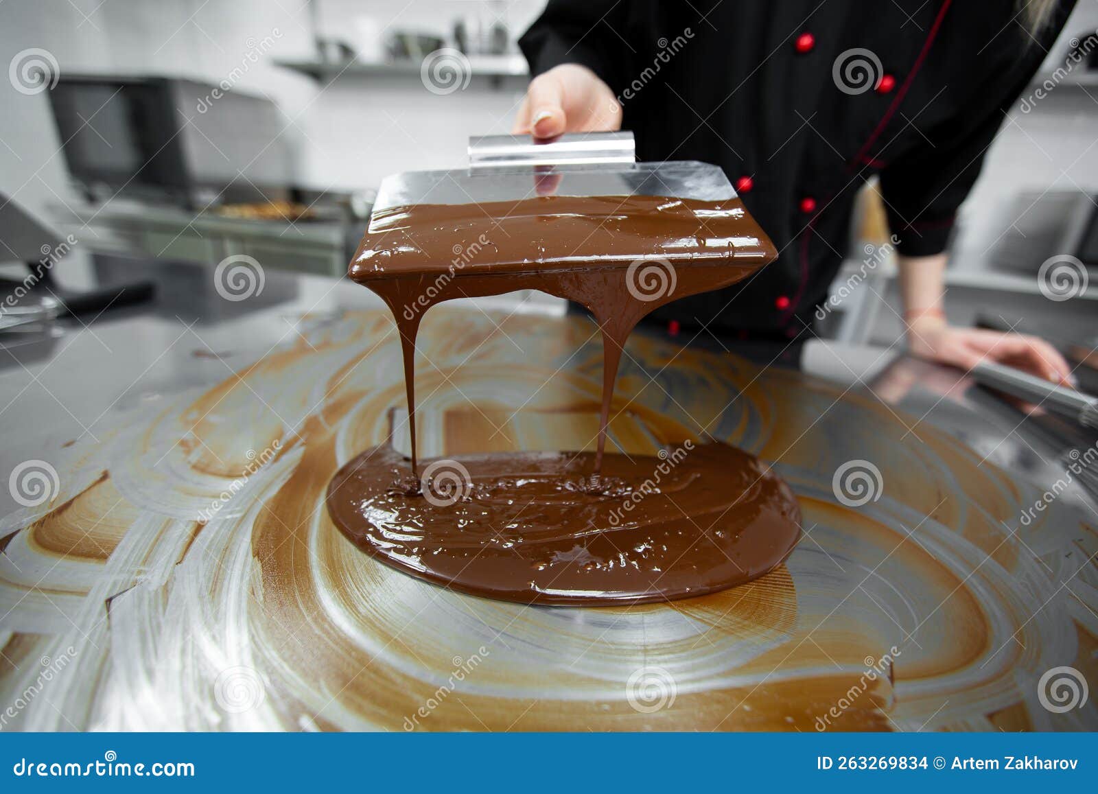 Close-up of a Pastry Chef Using Spatulas Tempering Molten Chocolate ...