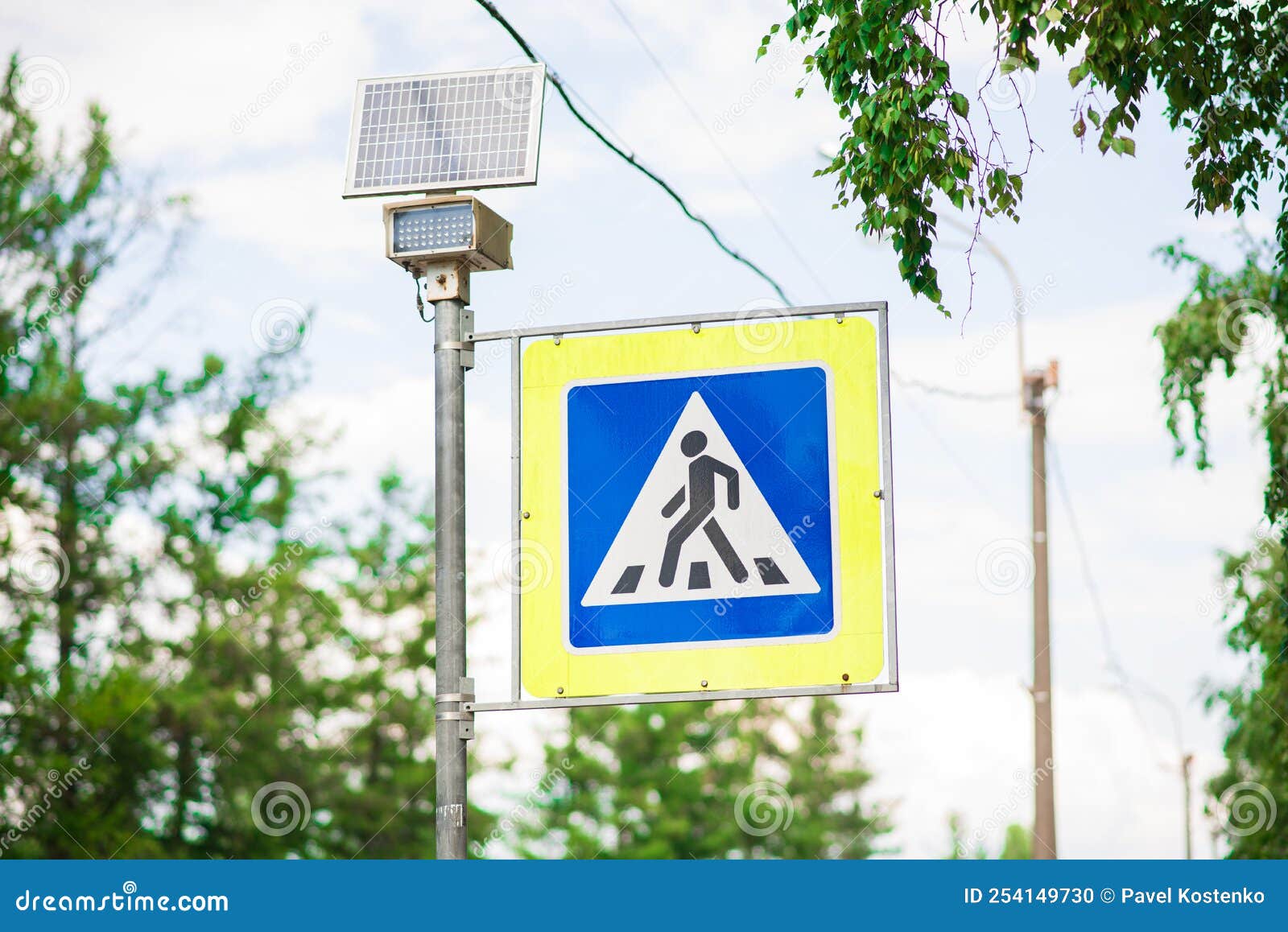A Close-up of a Pedestrian Crossing Sign with a Solar Panel Outside ...