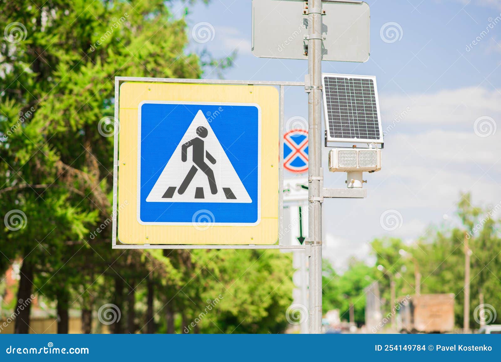 A Close-up of a Pedestrian Crossing Sign with a Solar Panel Outside ...