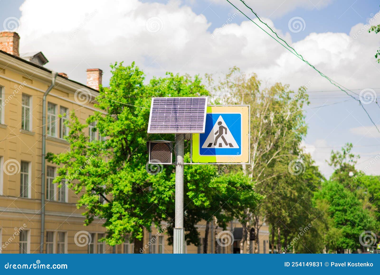 A Close-up of a Pedestrian Crossing Sign with a Solar Panel Outside ...