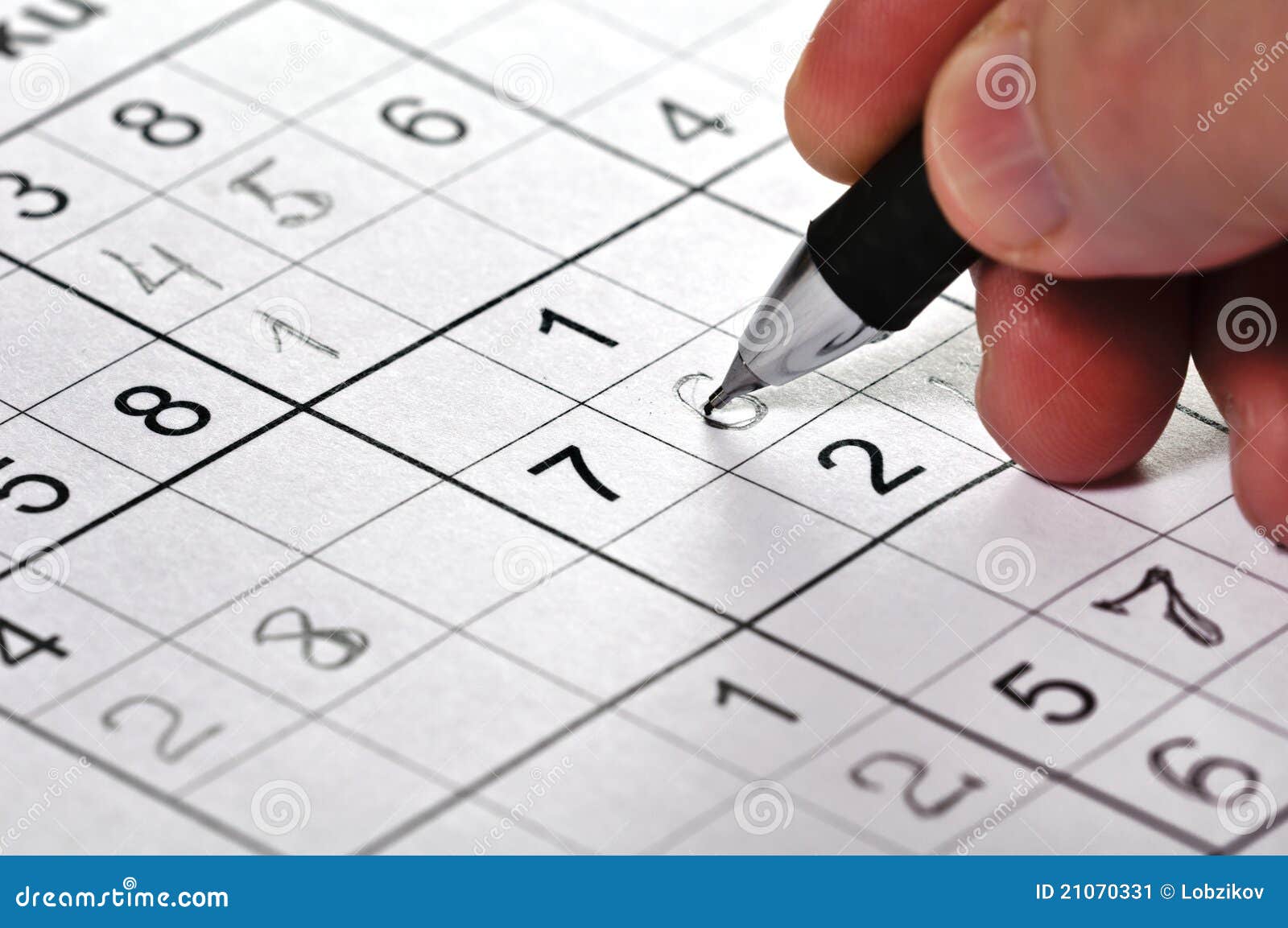 Close-up a Pencil in Hand and Puzzle Sudoku. Stock Image - Image of ...