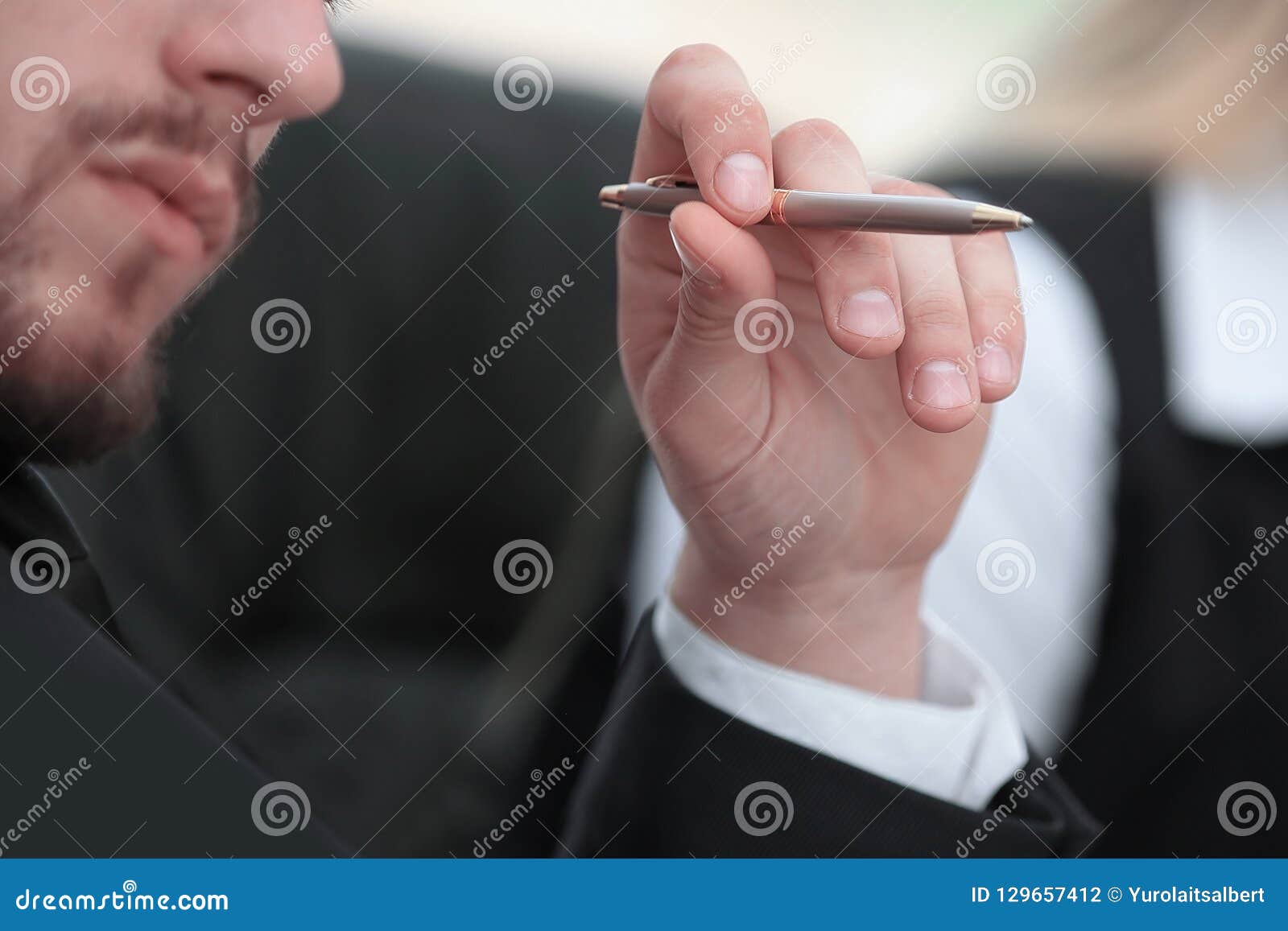 Close Up. Pensive Businessman with Pen Sitting at Table Stock Photo ...
