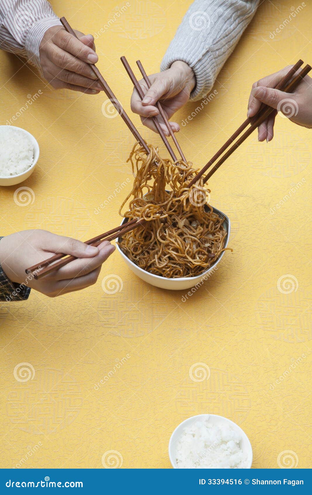Close Up of People Holding Chopsticks and Sharing One Dish Stock Photo ...