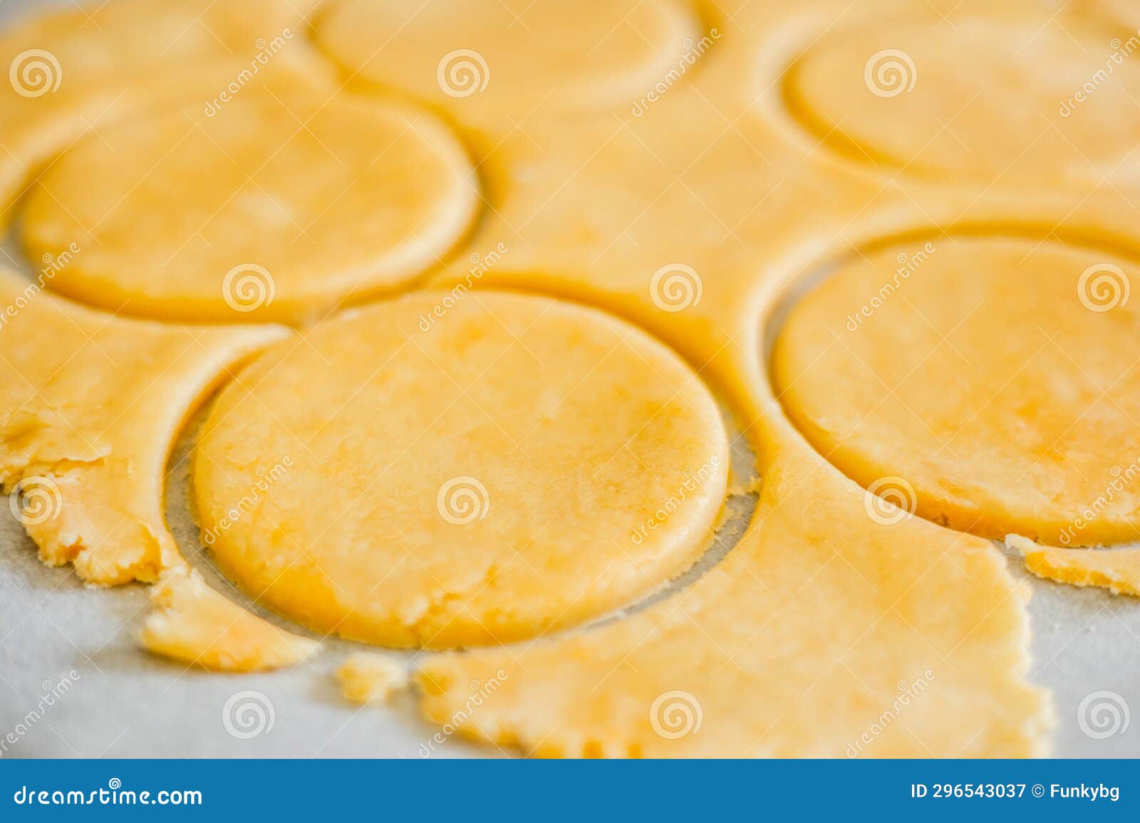 Close-up of Perfectly Cut Shortcrust Dough Circles in a Kitchen Setting ...
