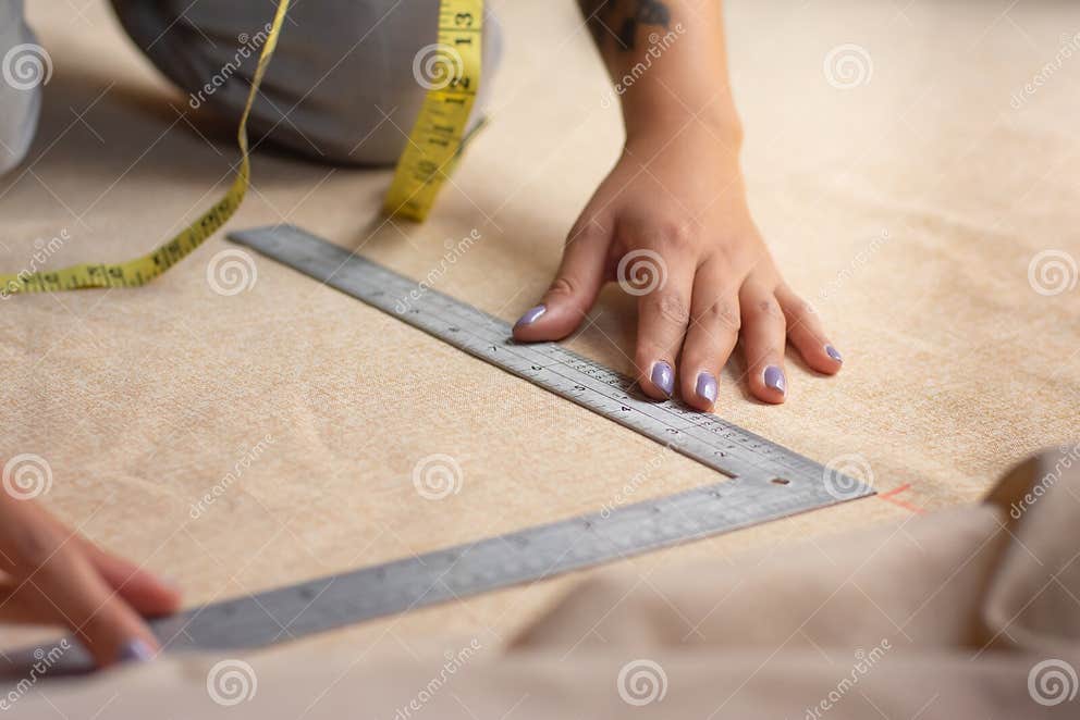Close Up of a Seamstress Woman Who is Measuring Fabric Using Rules ...