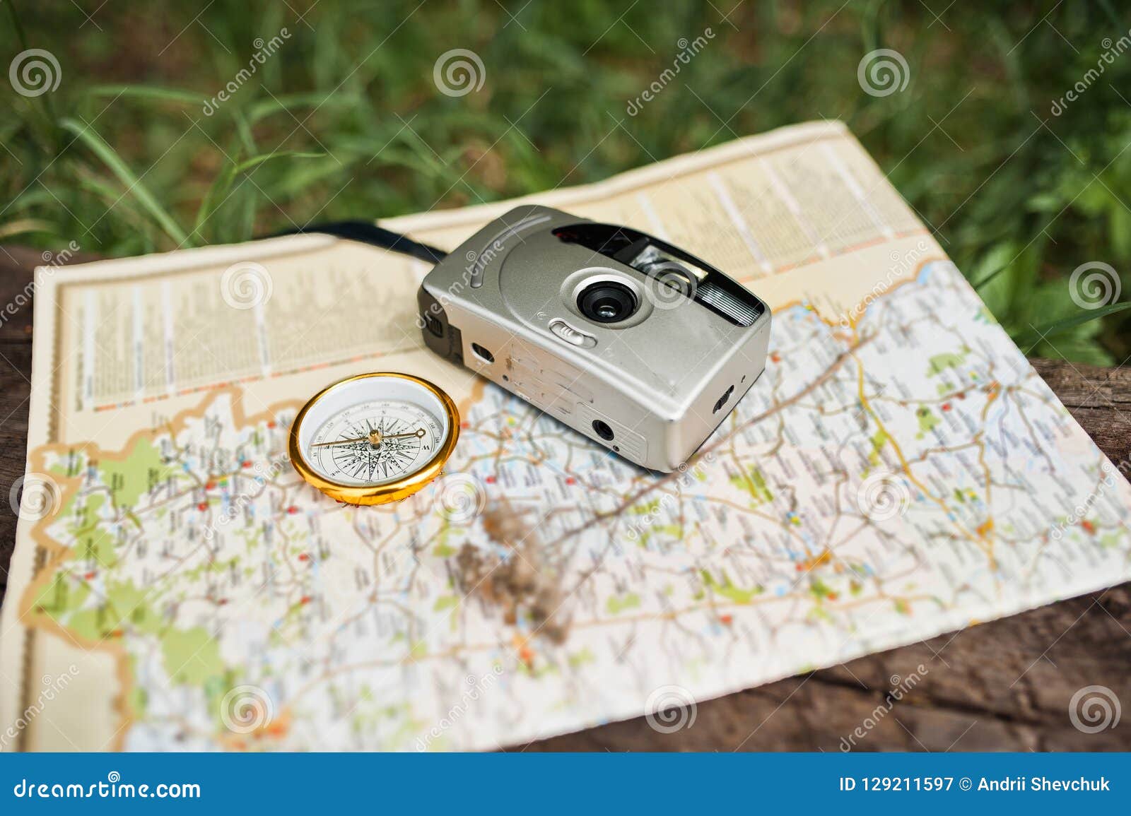 Close-up Photo of Compass Laying on the Map Next To the Camera. Stock ...