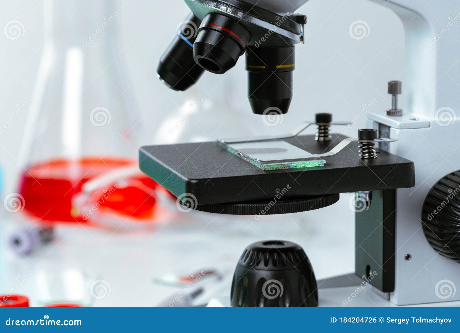 Close Up Photo of a Microscope Lenses Examining Glass Sample Stock ...