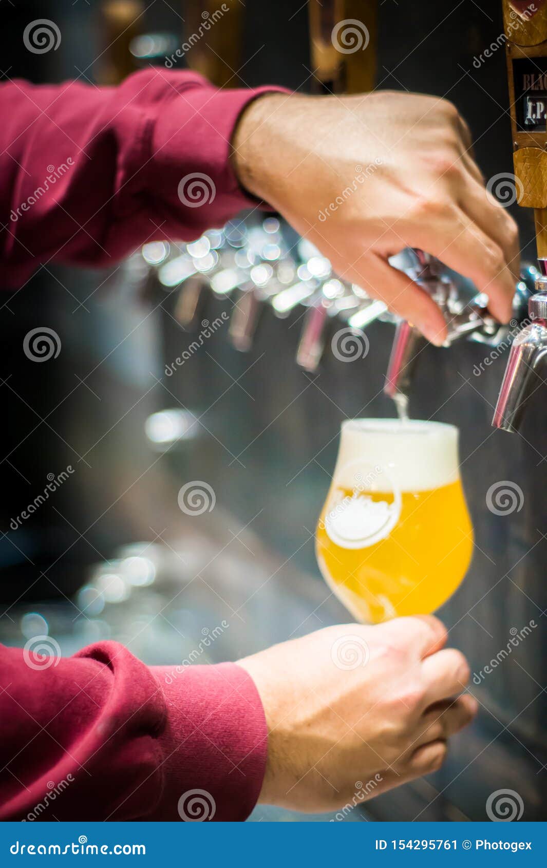Close Up Photo of Some Beer Taps and a Man Serving Stock Image - Image ...