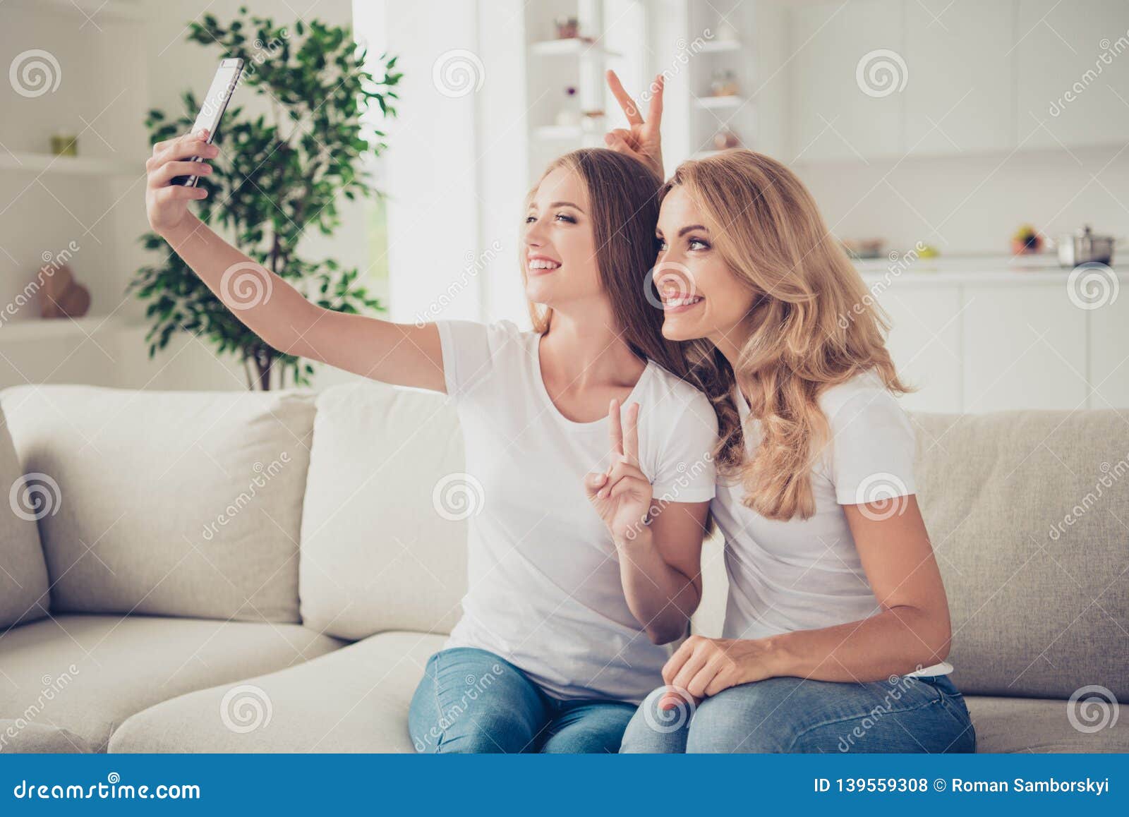 Close Up Photo Of Two People Mum And Teen Daughter Holding Hands Arms
