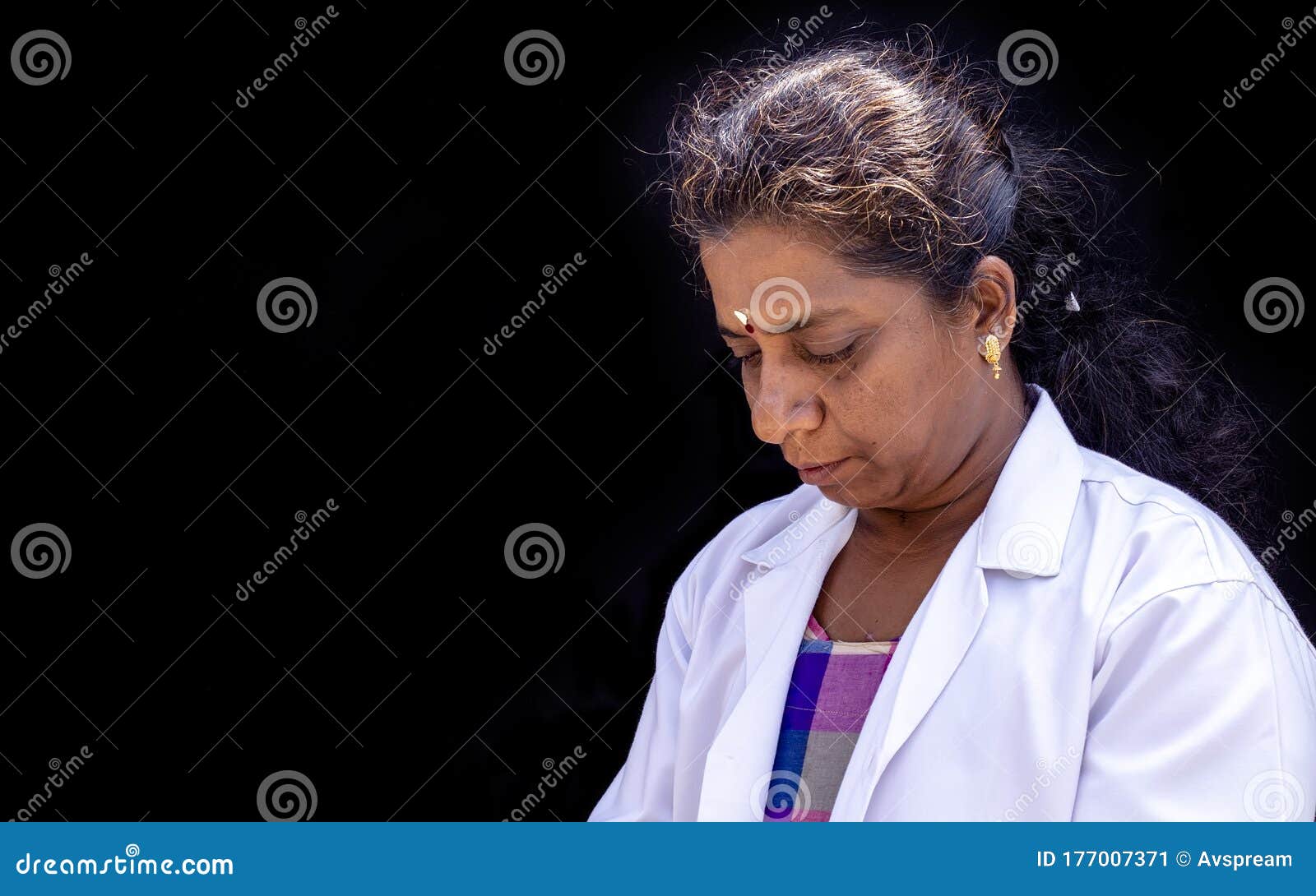 A Close Up Picture of a Doctor Looking Down at the Uniform on a Black ...